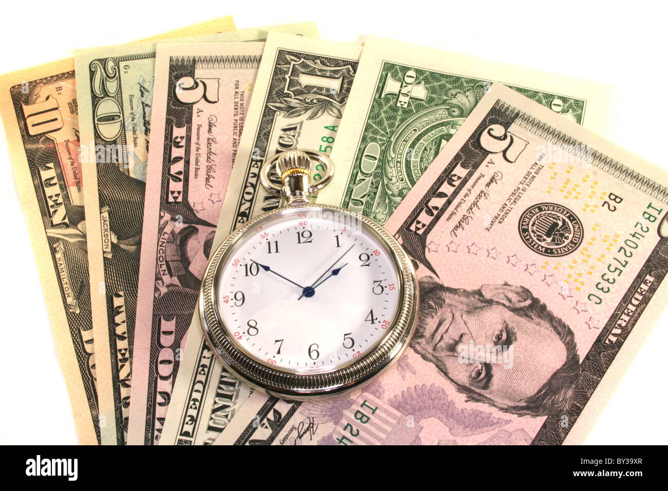many dollar bills with pocket watch on a white background Stock Photo ...