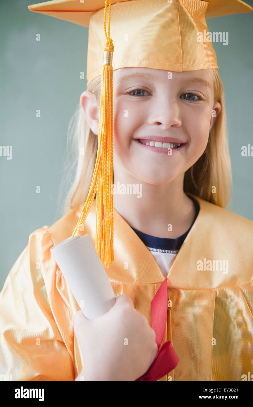 USA, New Jersey, Jersey City, Girl (8-9) wearing yellow mortar board ...
