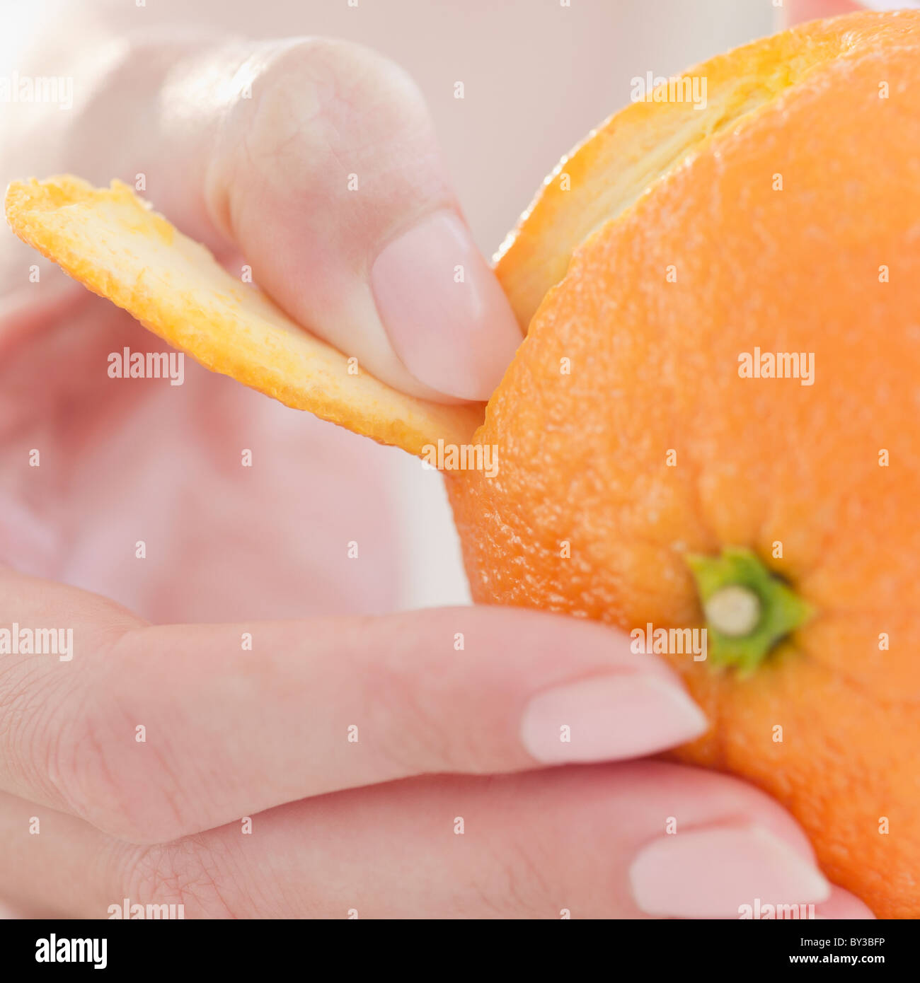 Womans hand peeling orange fruit hi-res stock photography and images ...