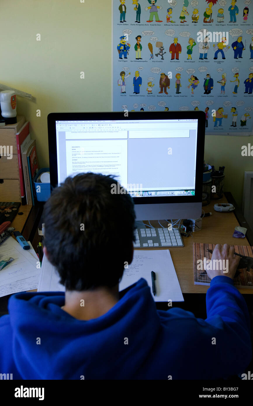 Student working in his bedroom with a messy desk and an Imac Stock ...