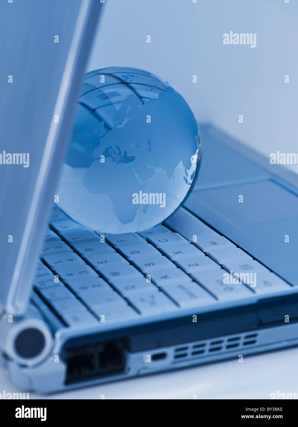 USA, New Jersey, Jersey City, Close-up view of blue laptop and globe ...