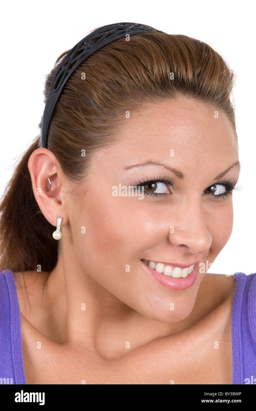 Woman gives a cute smile while turning her head sideways and looking ...