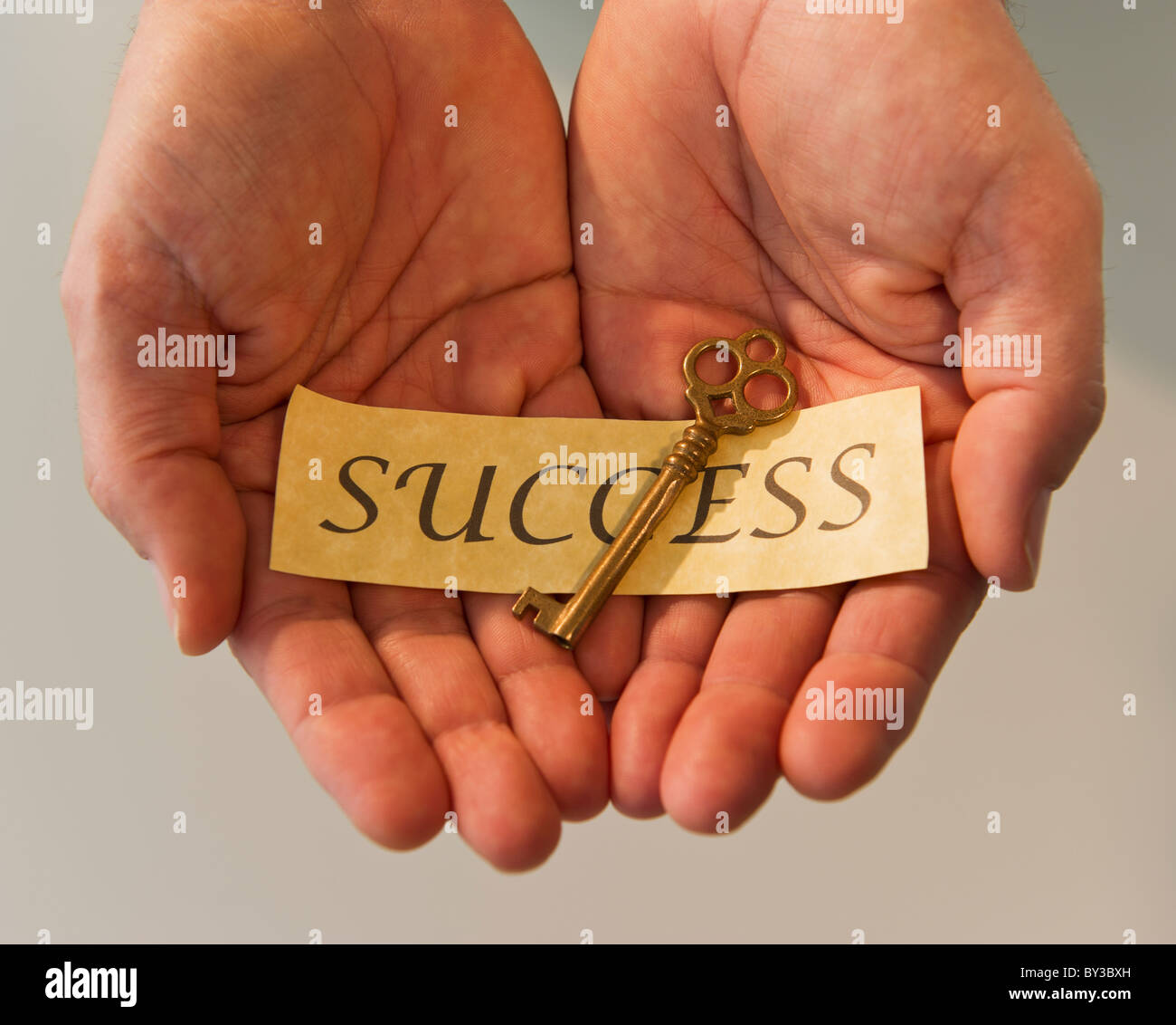 Hands holding key and label reading Success Stock Photo - Alamy