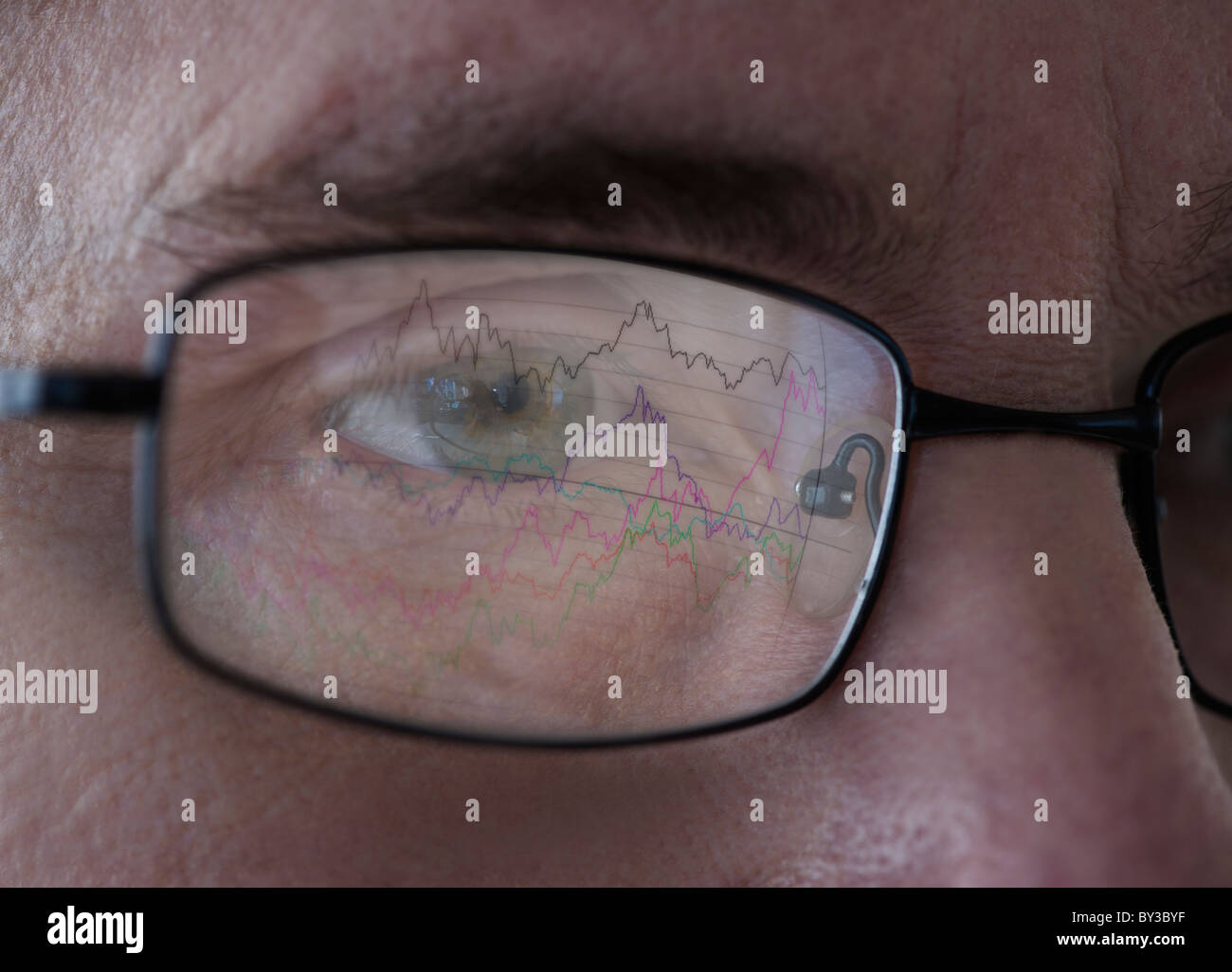 Close-up of man's eye with graph reflecting in glasses Stock Photo - Alamy