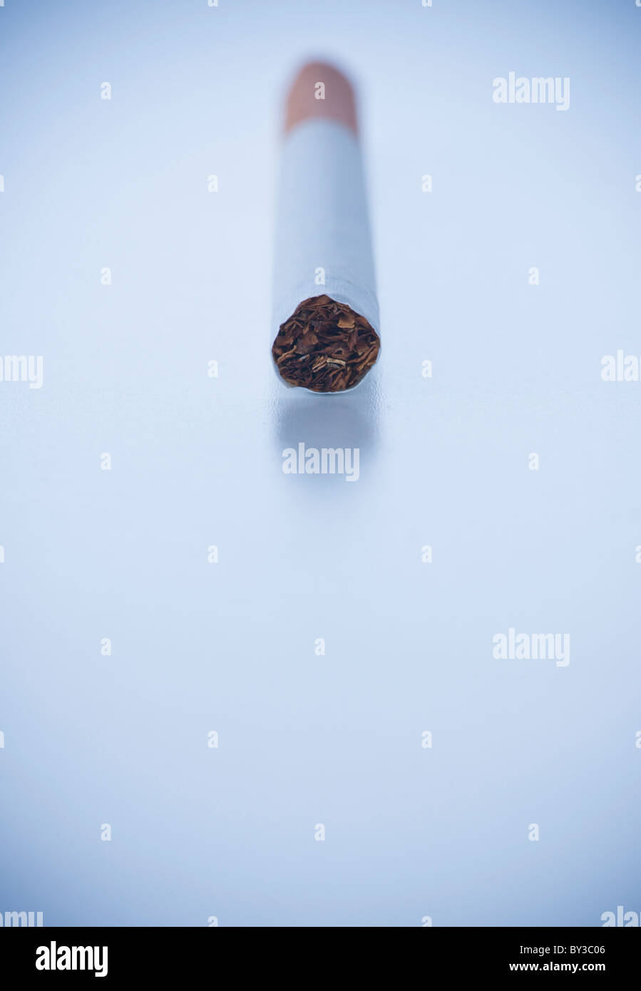 Cigarette on white background Stock Photo - Alamy