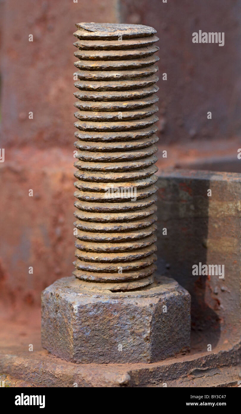 Giant rusty screw on a support of an electricity transmission. Close-up ...