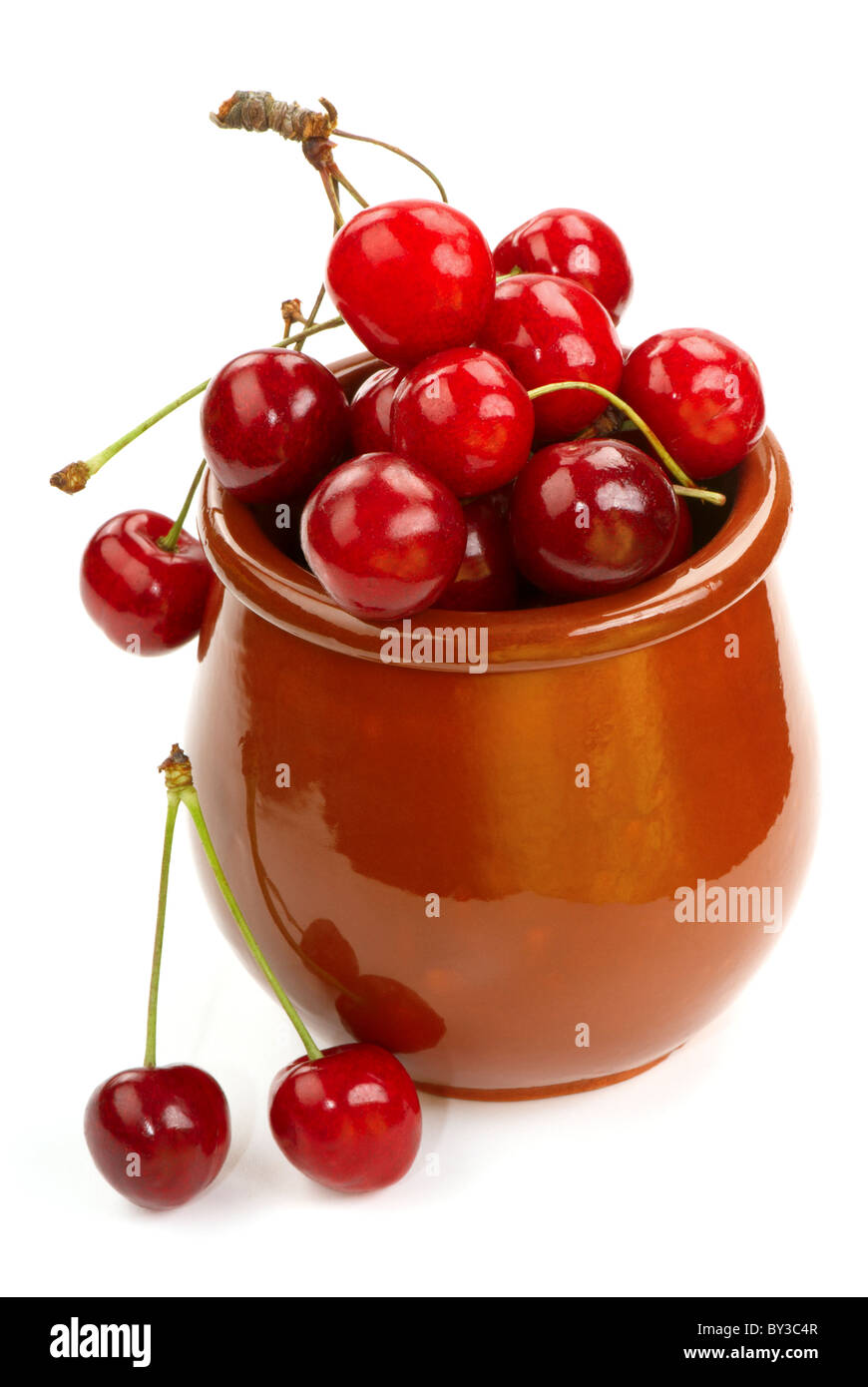 Ripe cherries in a clay pot on a white background Stock Photo - Alamy