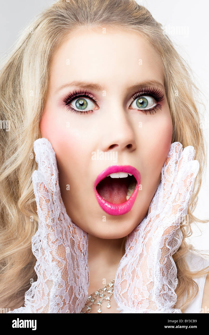 Blond young woman showing an expression of surprise/shock Stock Photo ...