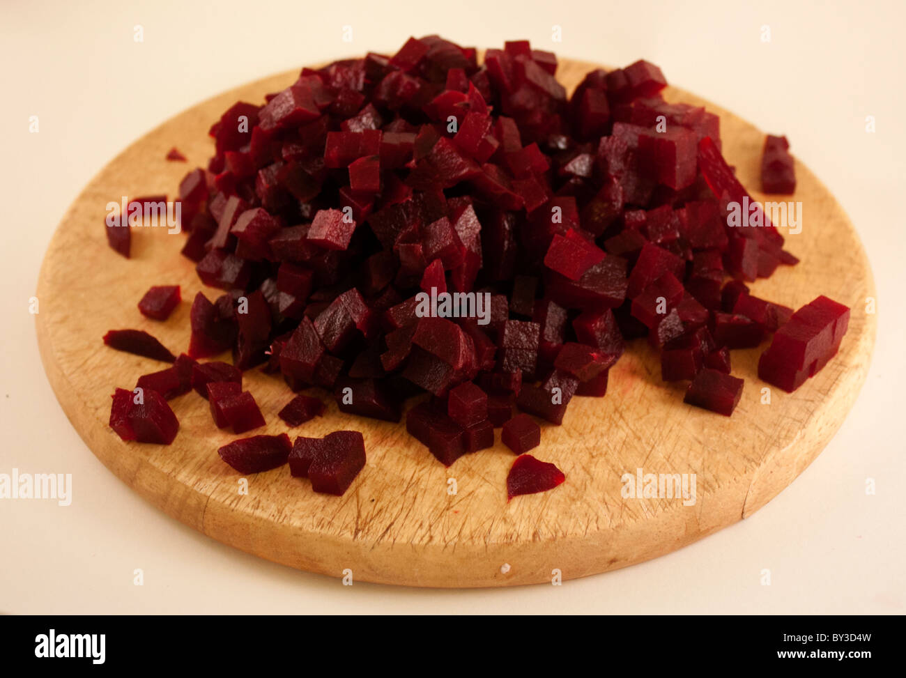 chopped cooked beetroot on a round wooden board Stock Photo - Alamy