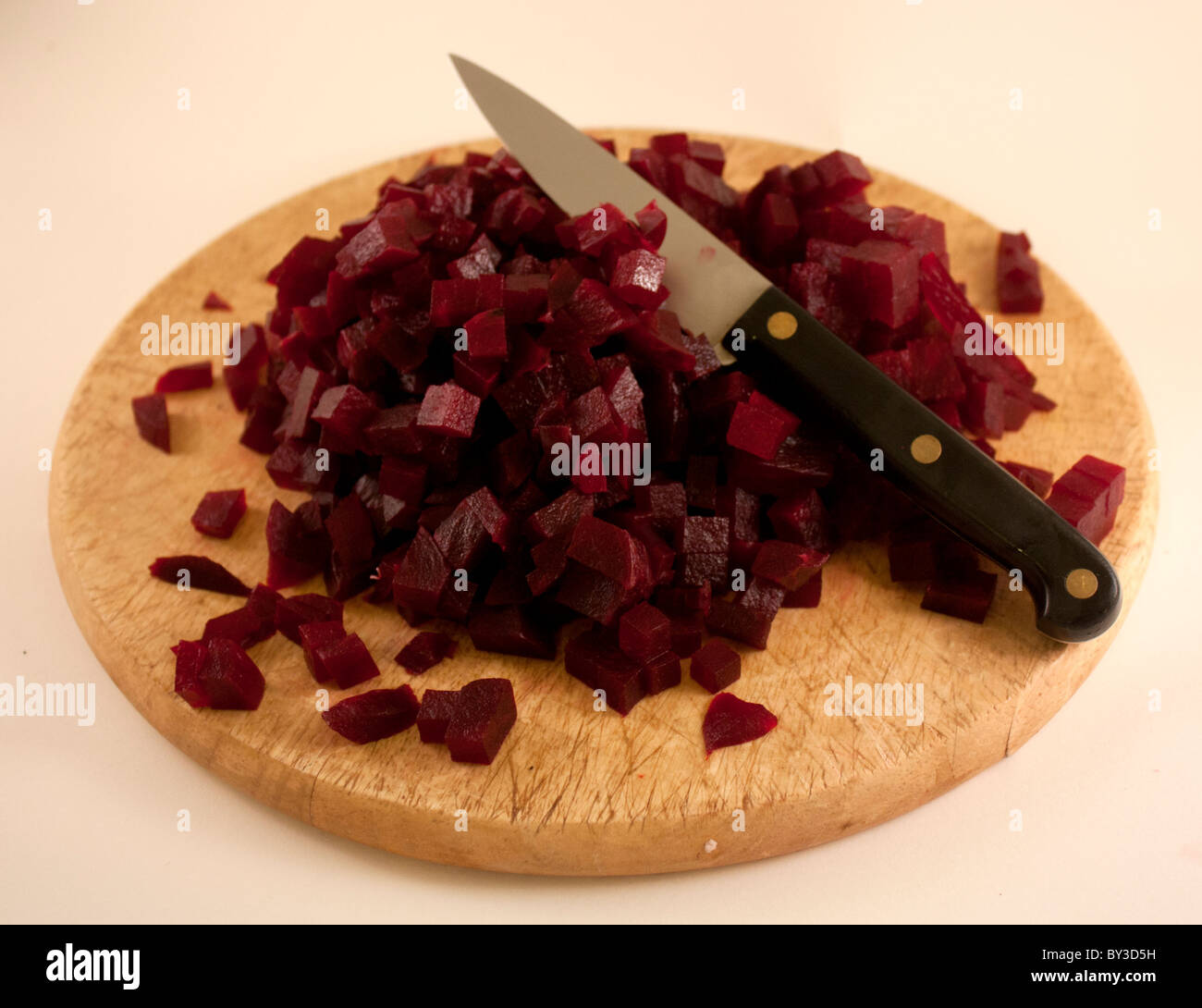 chopped beetroot on a round wooden board with knife Stock Photo - Alamy