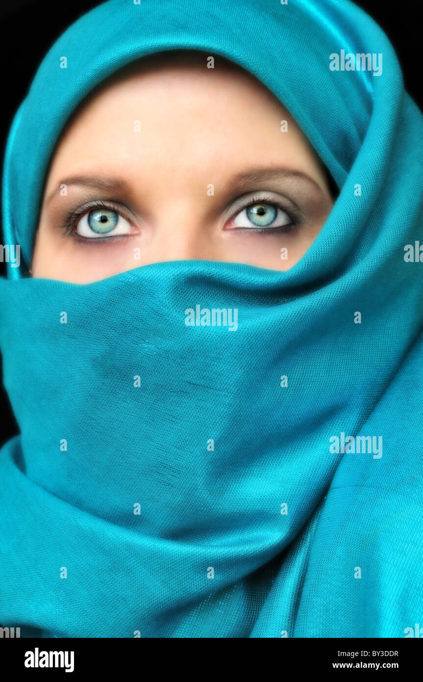Young woman with blue eyes covered in a blue scarf (muslim style Stock ...