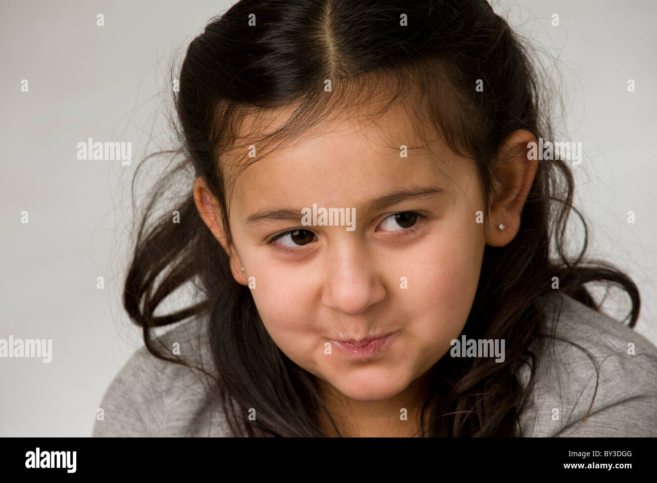 Close up portrait of young girl pulling a face Stock Photo - Alamy