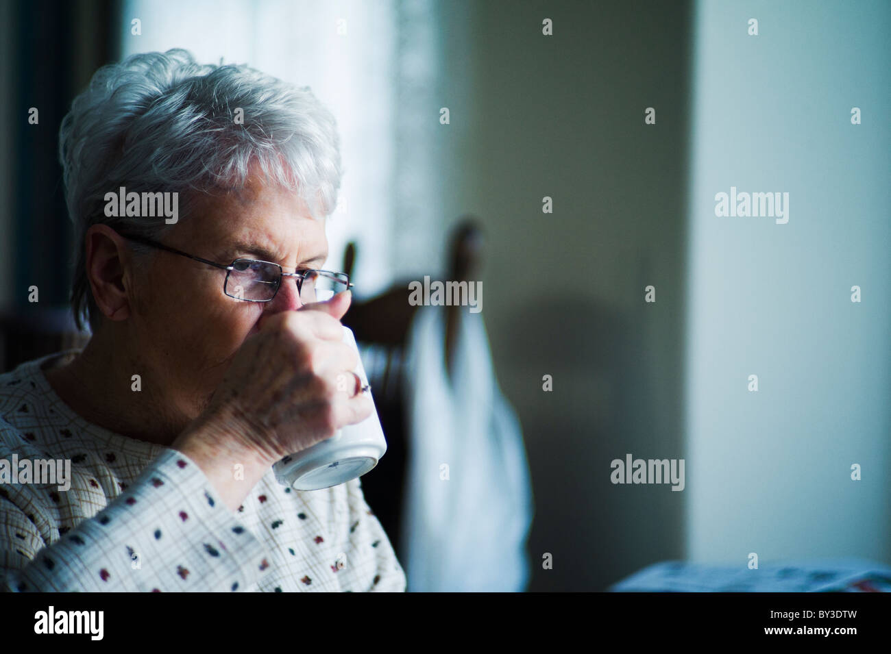 Old woman drinking tea Stock Photo - Alamy