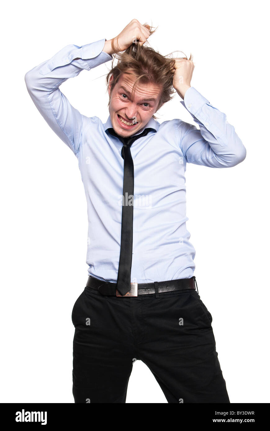 Young man so angry that he wants to pull his hair out. Studio photo ...