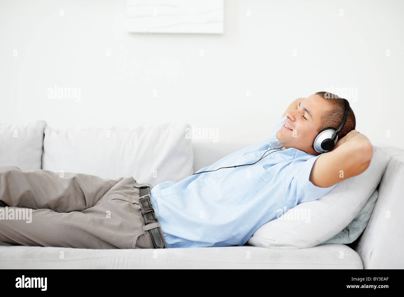 South Africa, Man relaxing while listening music Stock Photo - Alamy