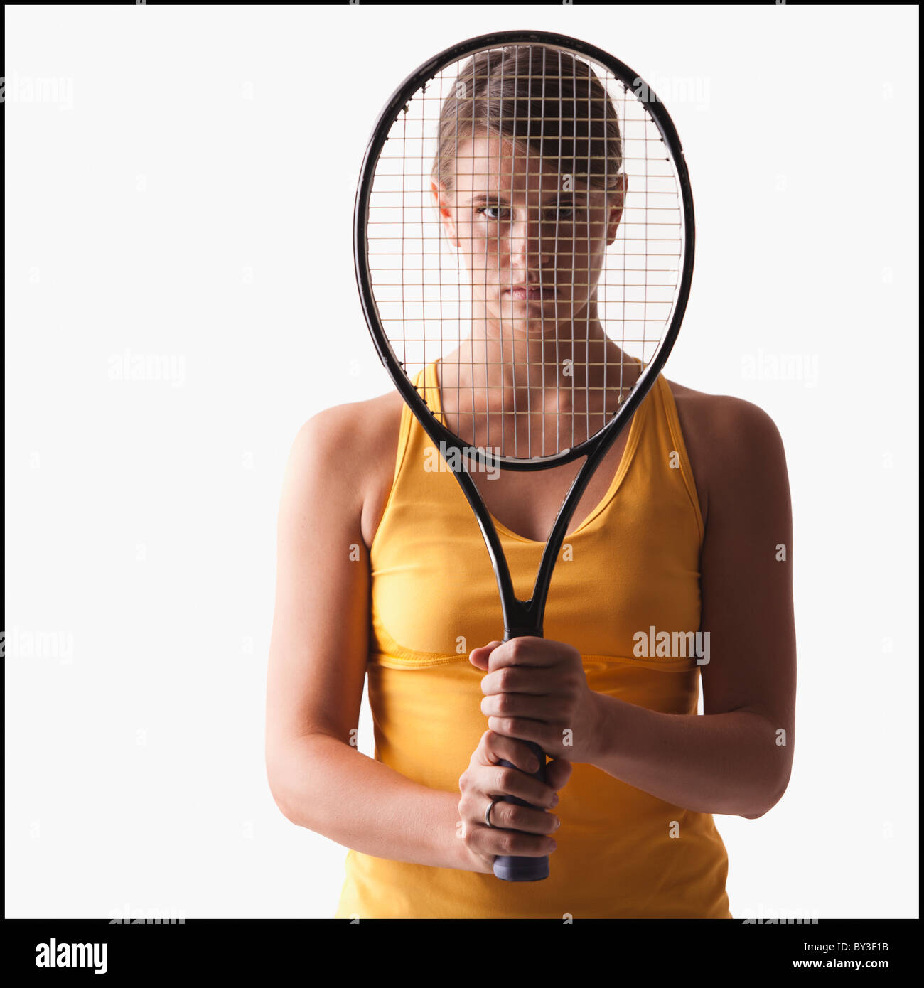Young woman holding tennis racket Stock Photo - Alamy