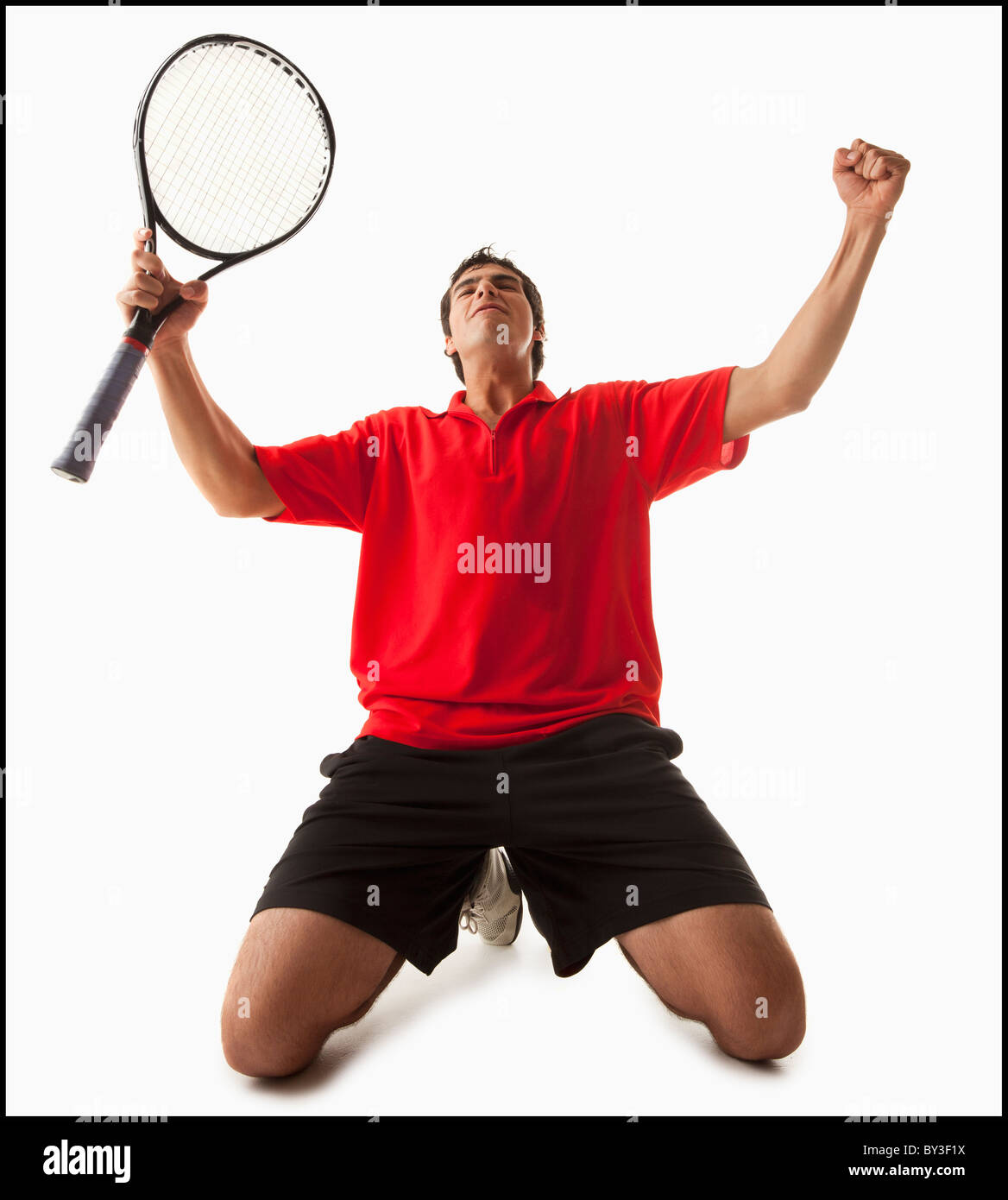 Young man playing tennis winning Stock Photo - Alamy