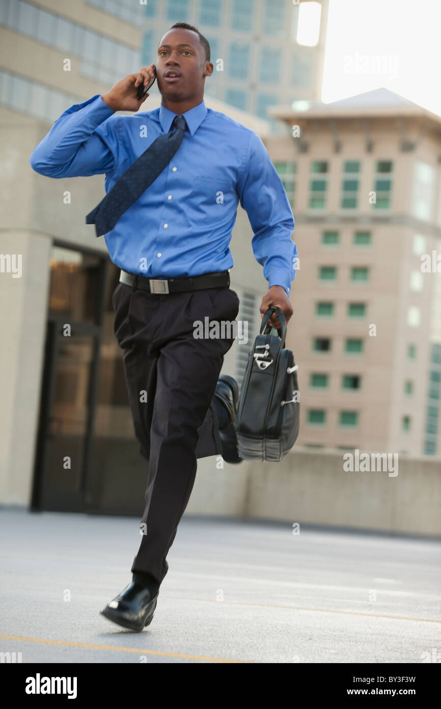 Business man running cell phone hi-res stock photography and images - Alamy
