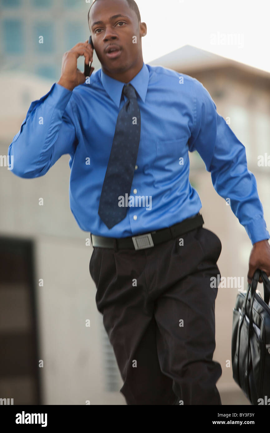 Business man running cell phone hi-res stock photography and images - Alamy