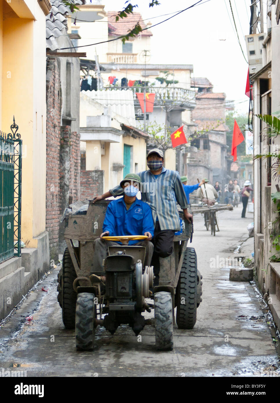 Ancient tractor being driven through the streets of Minh Hai in Viet ...