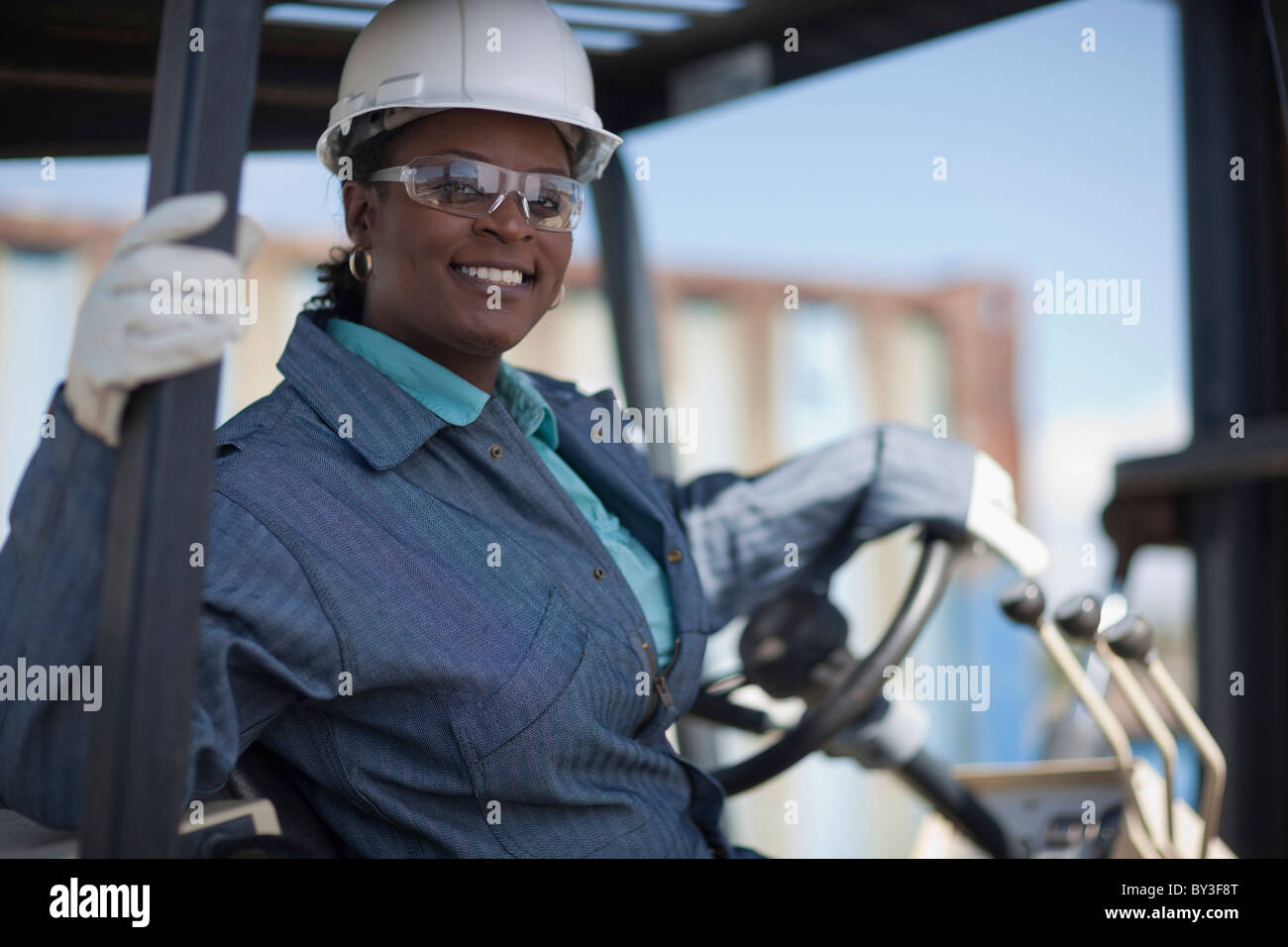 Portrait of female construction worker driving mechanical digger Stock ...