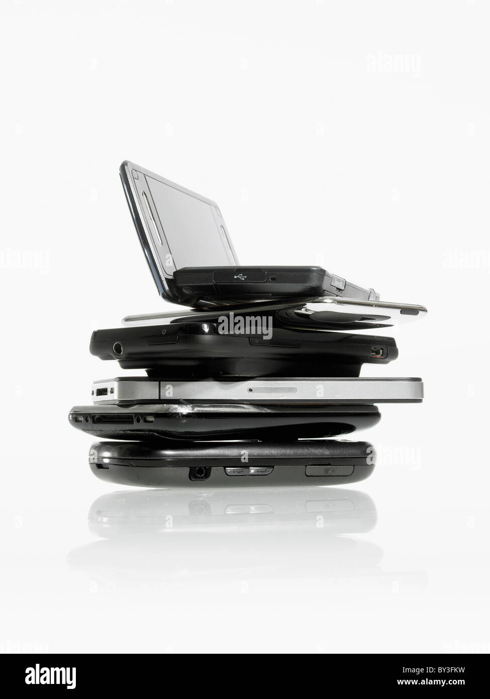 Studio shot of pile of laptops and palmtops Stock Photo - Alamy