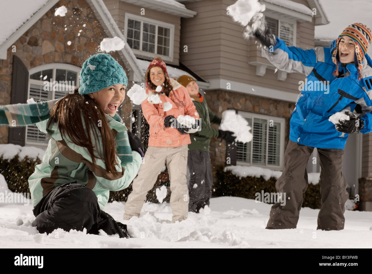 Happy kids playing snowball fight hi-res stock photography and images ...