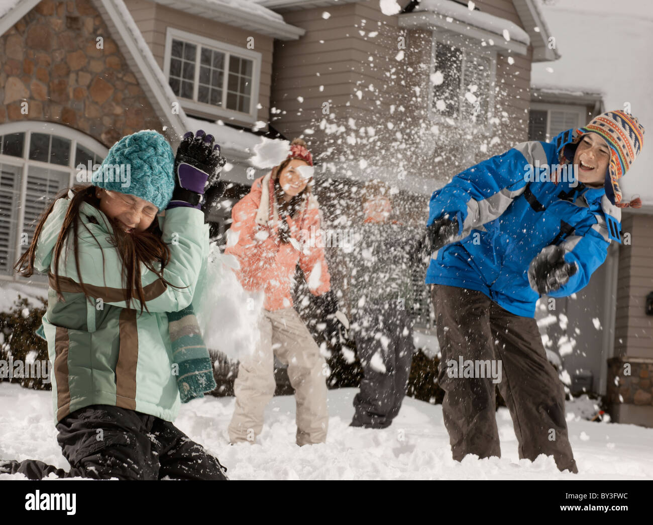 Happy kids playing snowball fight hi-res stock photography and images ...