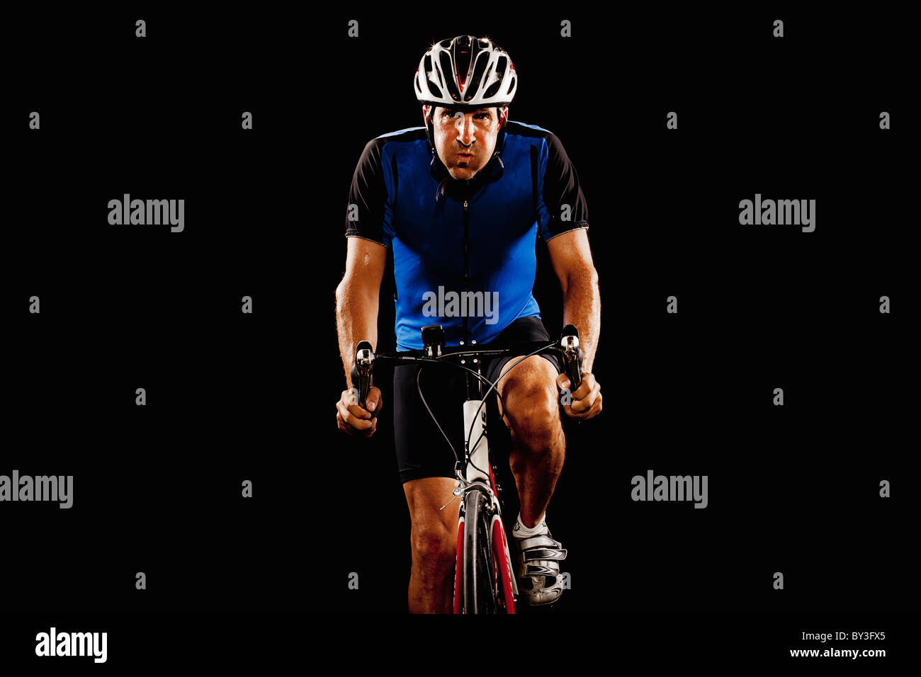 Studio portrait of man cycling Stock Photo - Alamy