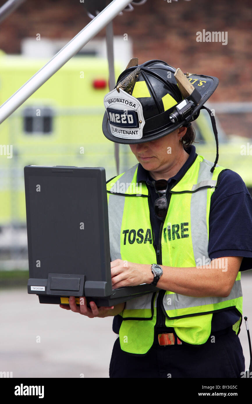 Female fire fighter on the scene of a hazardous chemical spill Stock ...