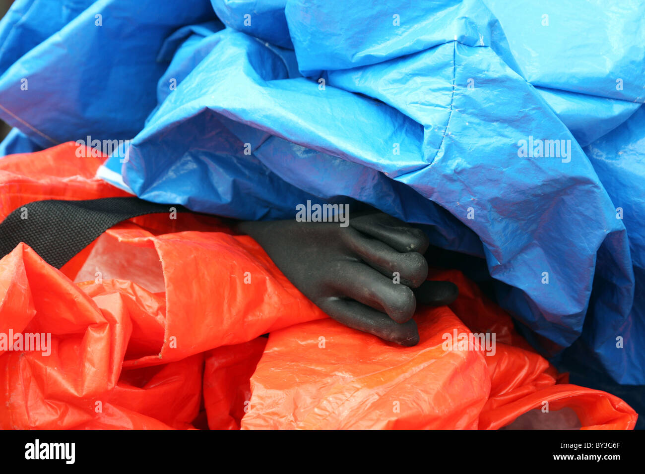 An orange and blue hazmat suit worn by fire fighters for hazardous ...