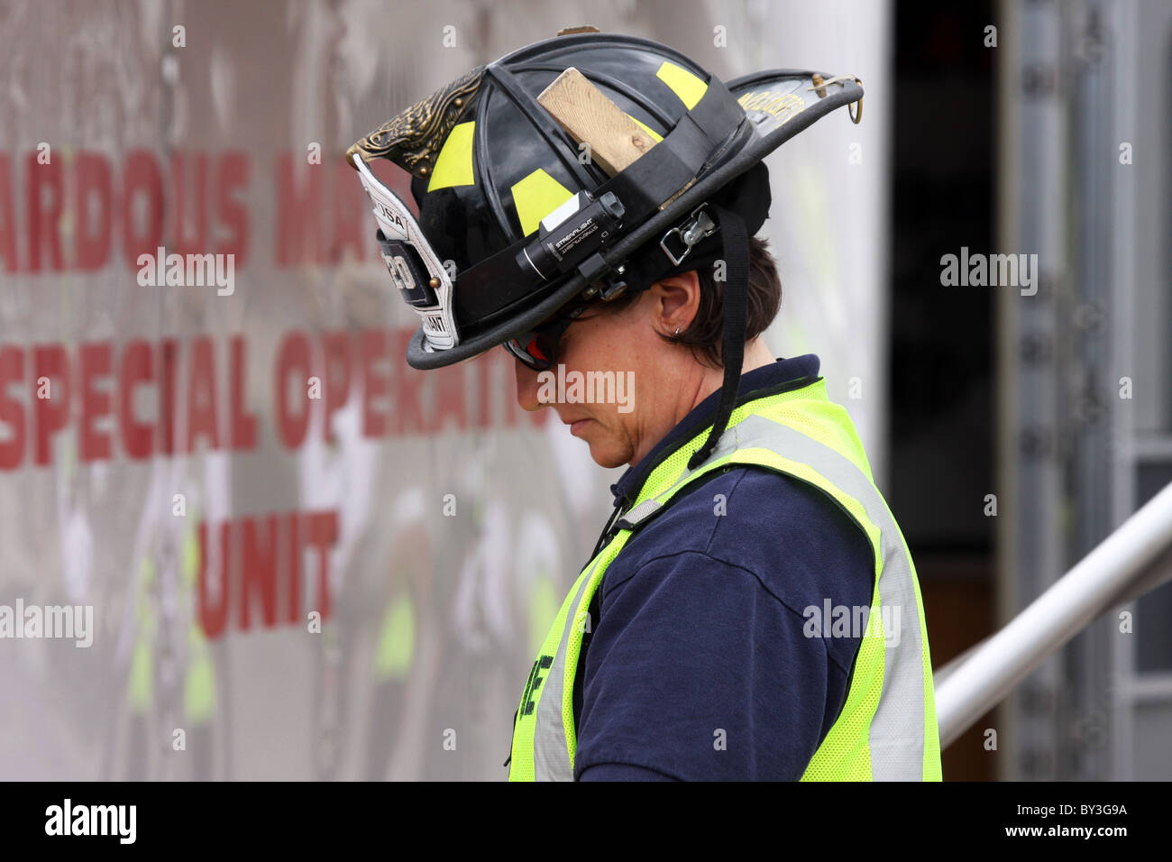 Female fire fighter on the scene of a hazardous chemical spill Stock ...