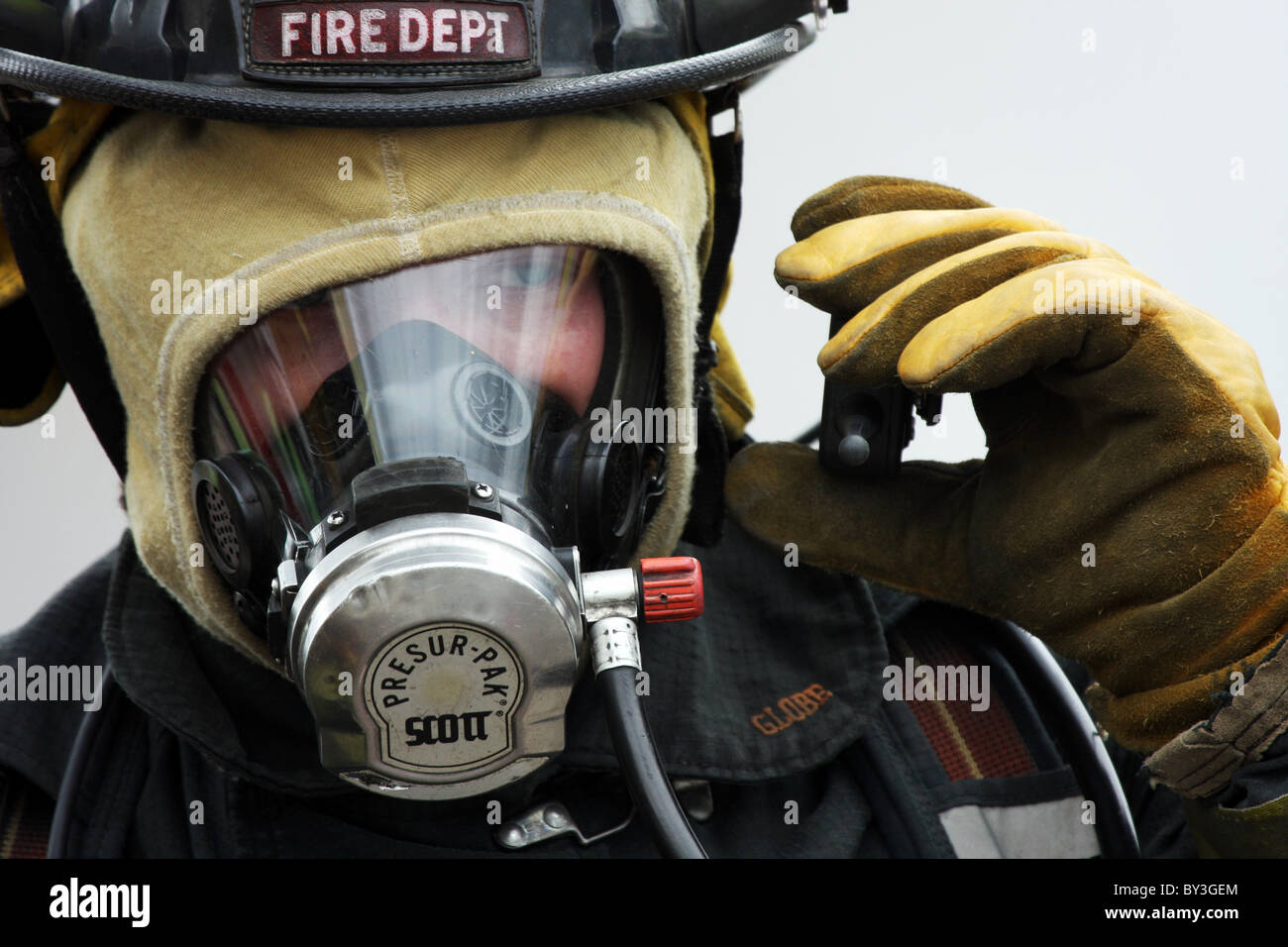 A firefighter listening to the radio caller by his ear Stock Photo - Alamy