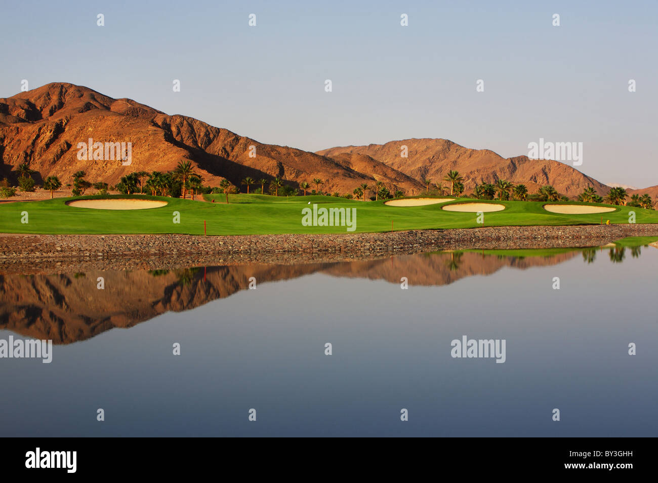 Golf player on golf course at sunrise Stock Photo - Alamy