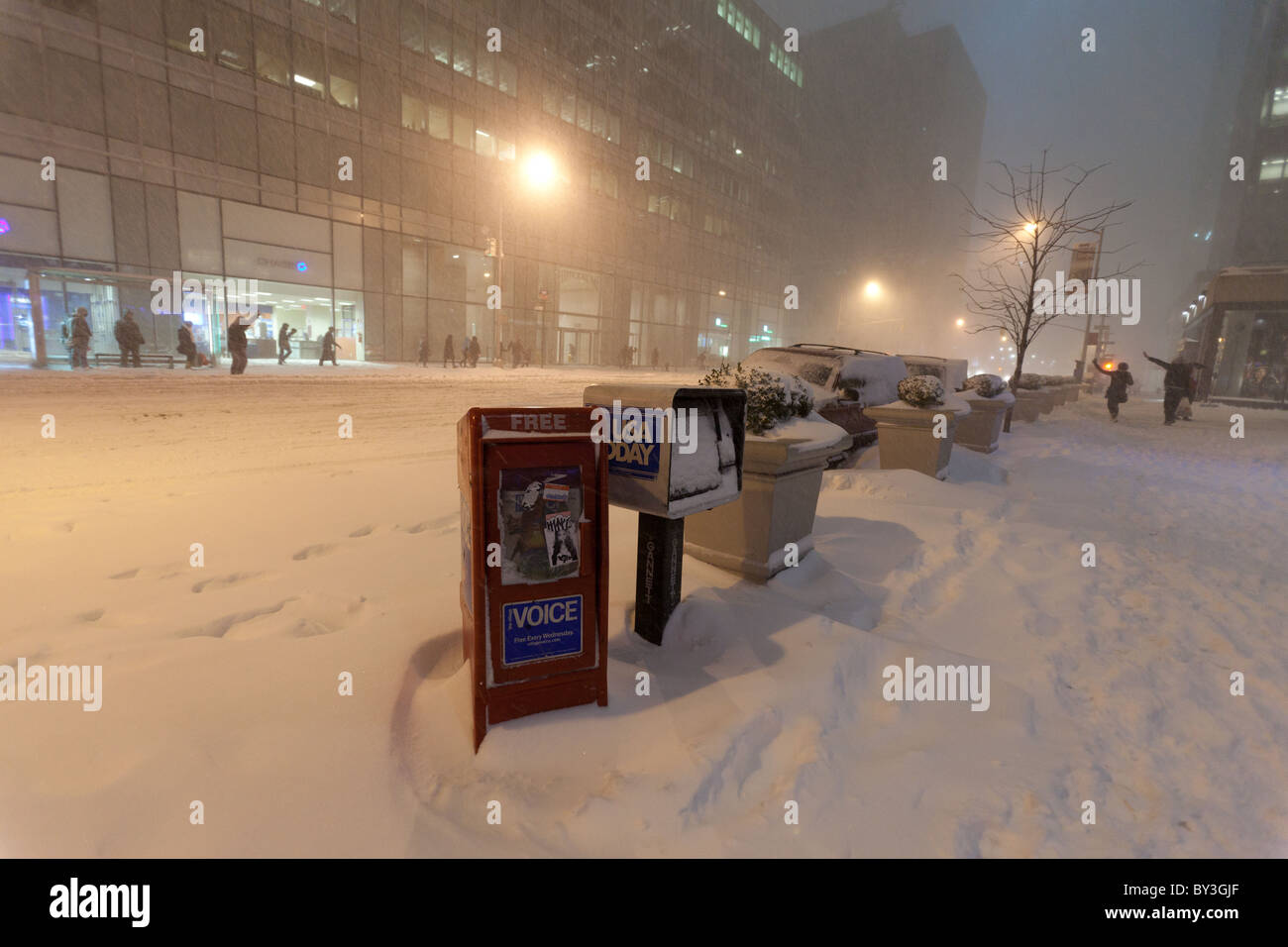 Newspaper boxes on 6th Avenue covered in a thick snow blanket during ...