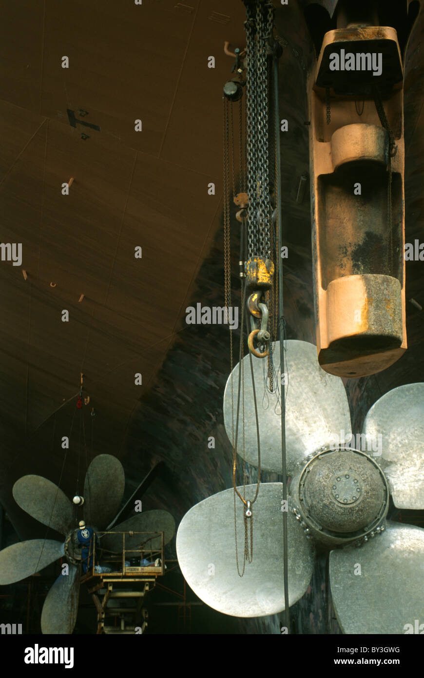 Shipyard worker working on propeller of ship under construction at ...