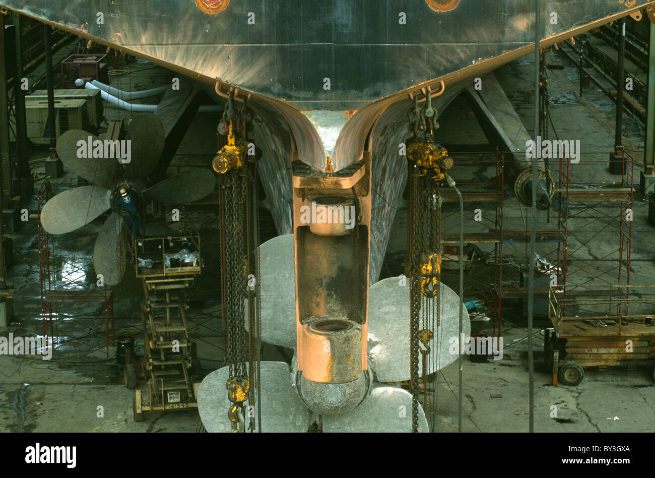 Shipyard worker working on propeller of ship under construction at ...