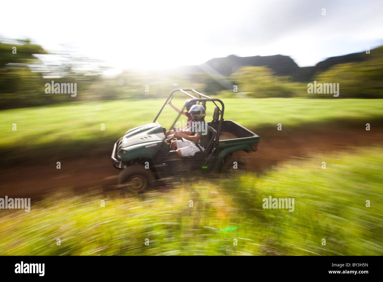 A couple race around a tight corner in an ATV while partaking in an off ...