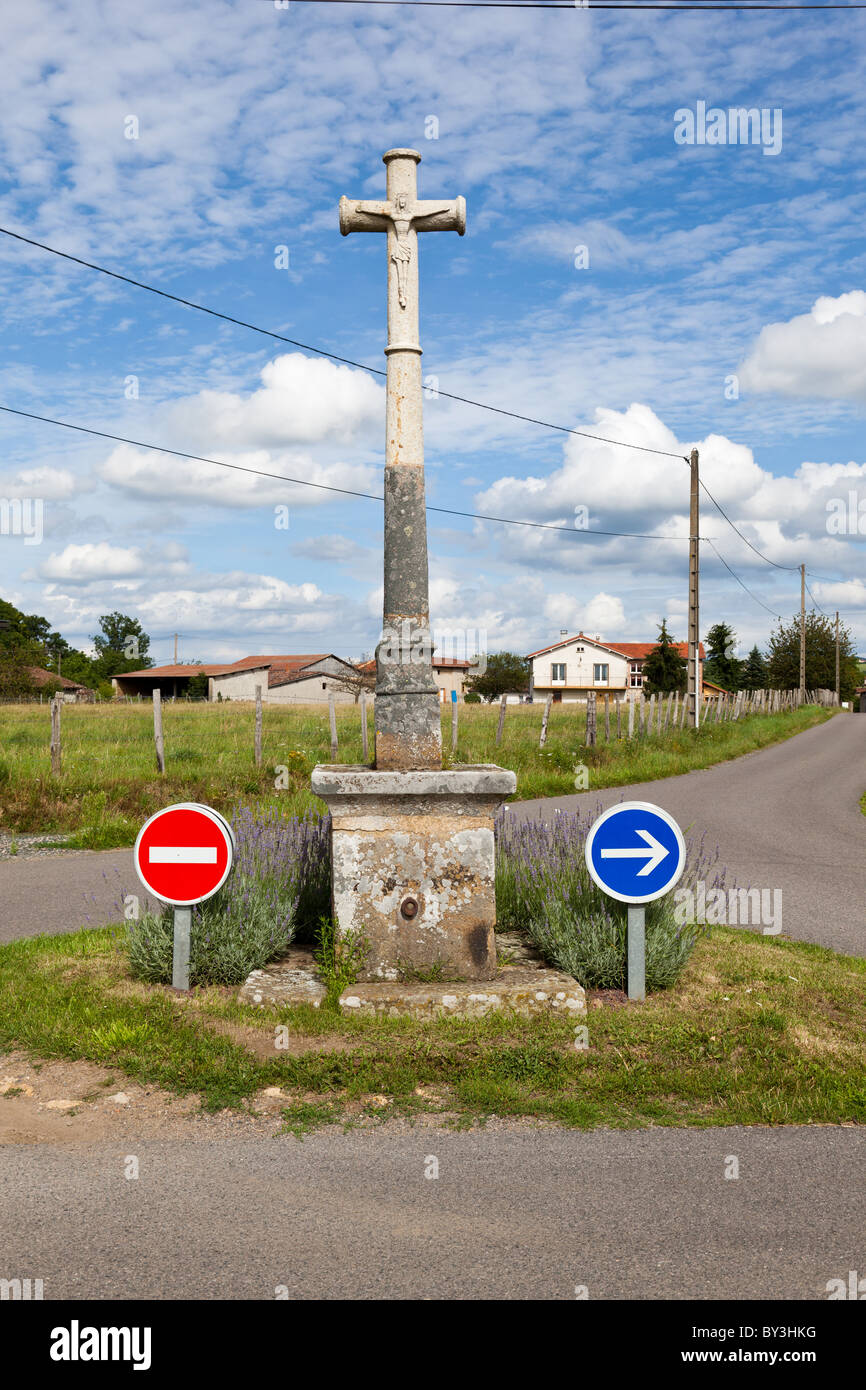 Statue of Jesus on cross at road junction in Saint Medar en Forez in ...