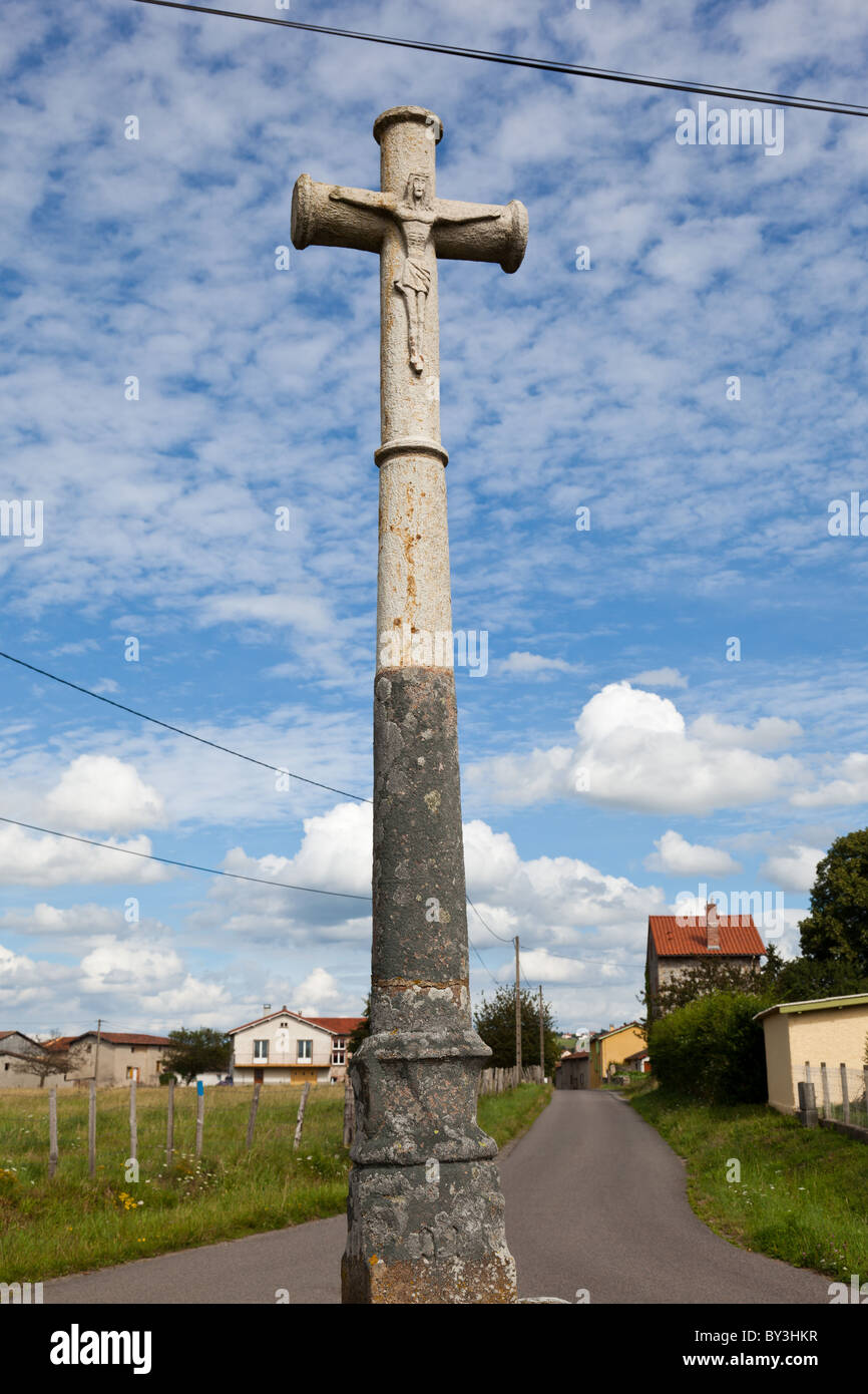 Statue of Jesus on cross at road junction in Saint Medar en Forez in ...