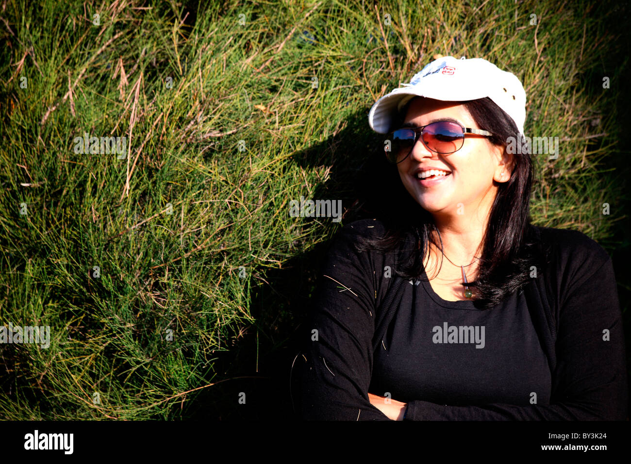 A portrait of Indian woman against tree leaves background Stock Photo ...