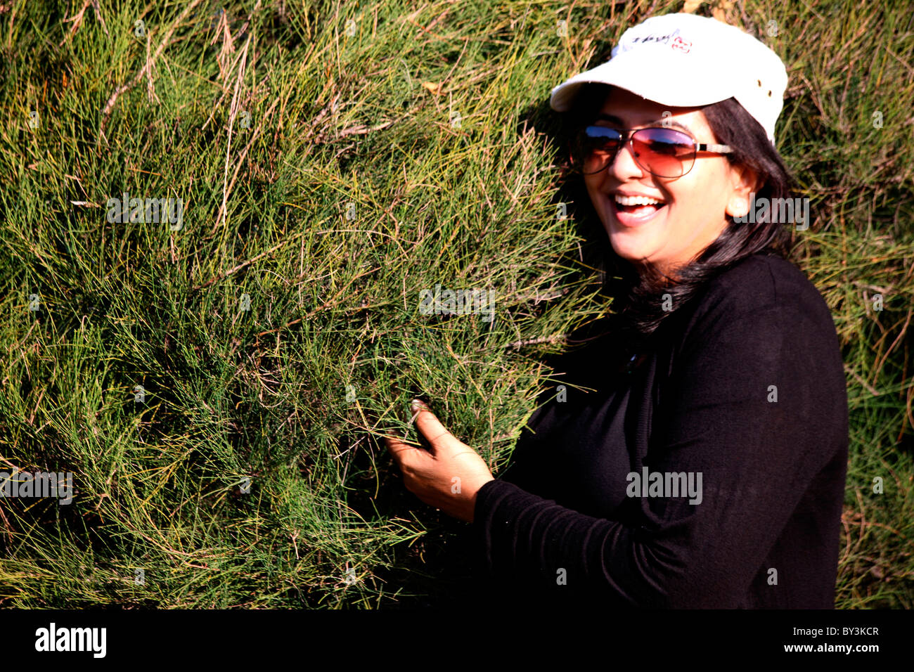 A portrait of Indian woman against tree leaves background Stock Photo ...