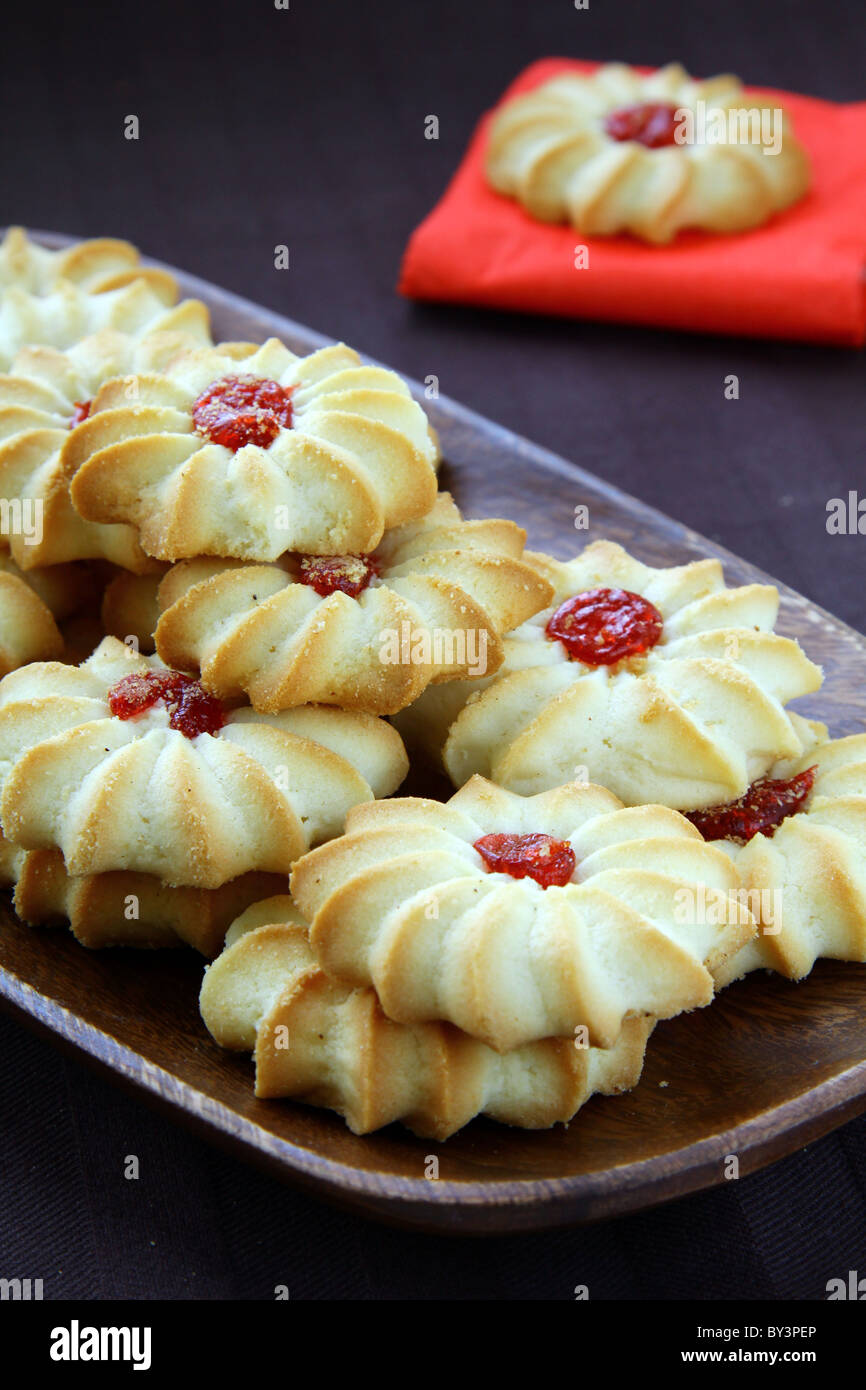 Beautiful cookies with jam on a brown background Stock Photo - Alamy