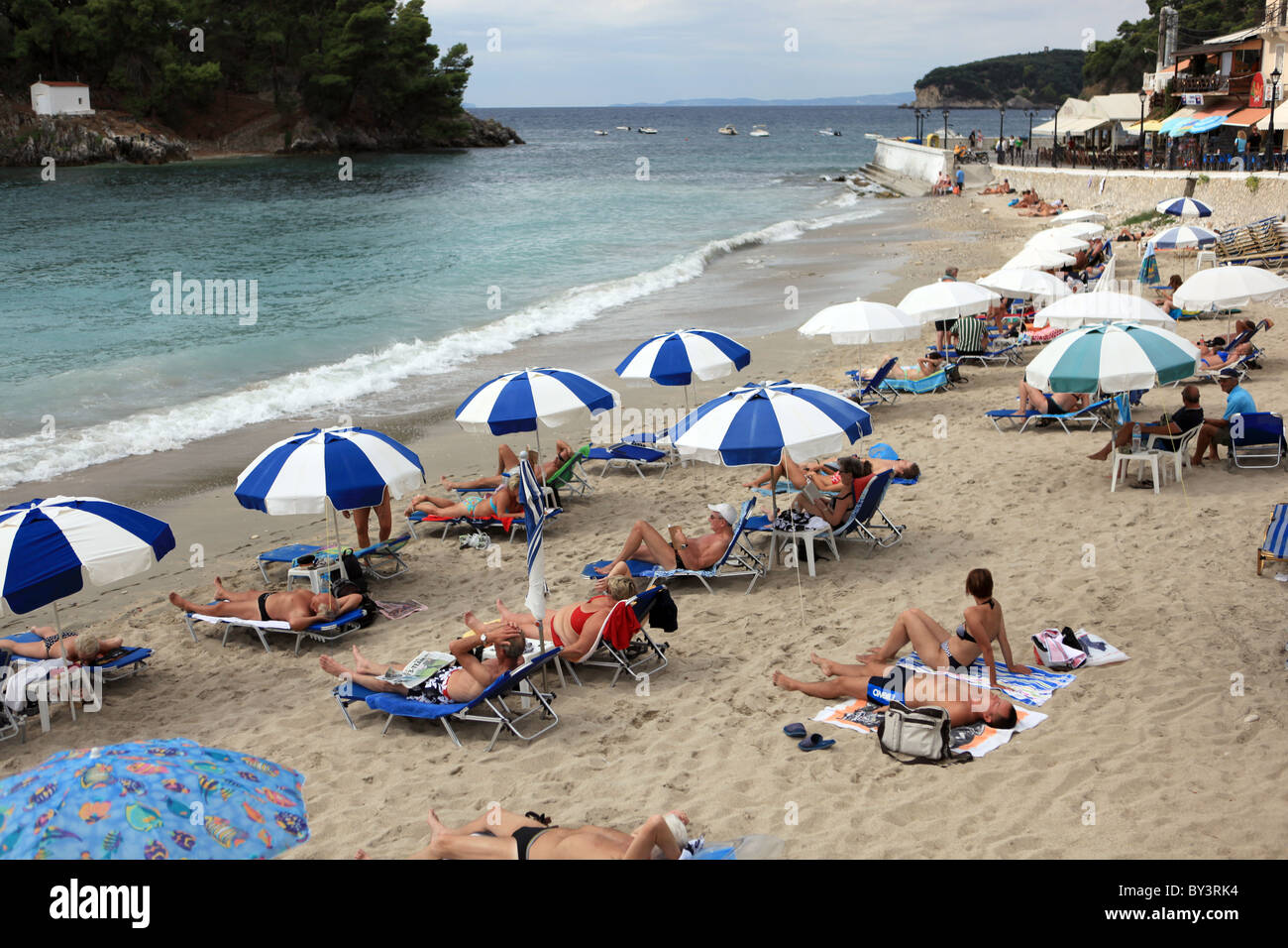 The sandy beach at the hillside town of Parga on the west coast of ...