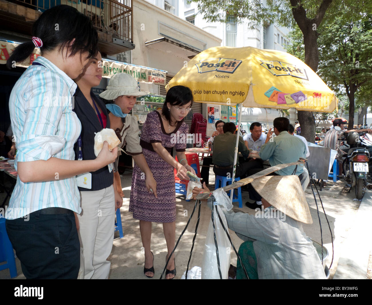 Office workers buying street food for their lunch break, Ho Chi Minh ...