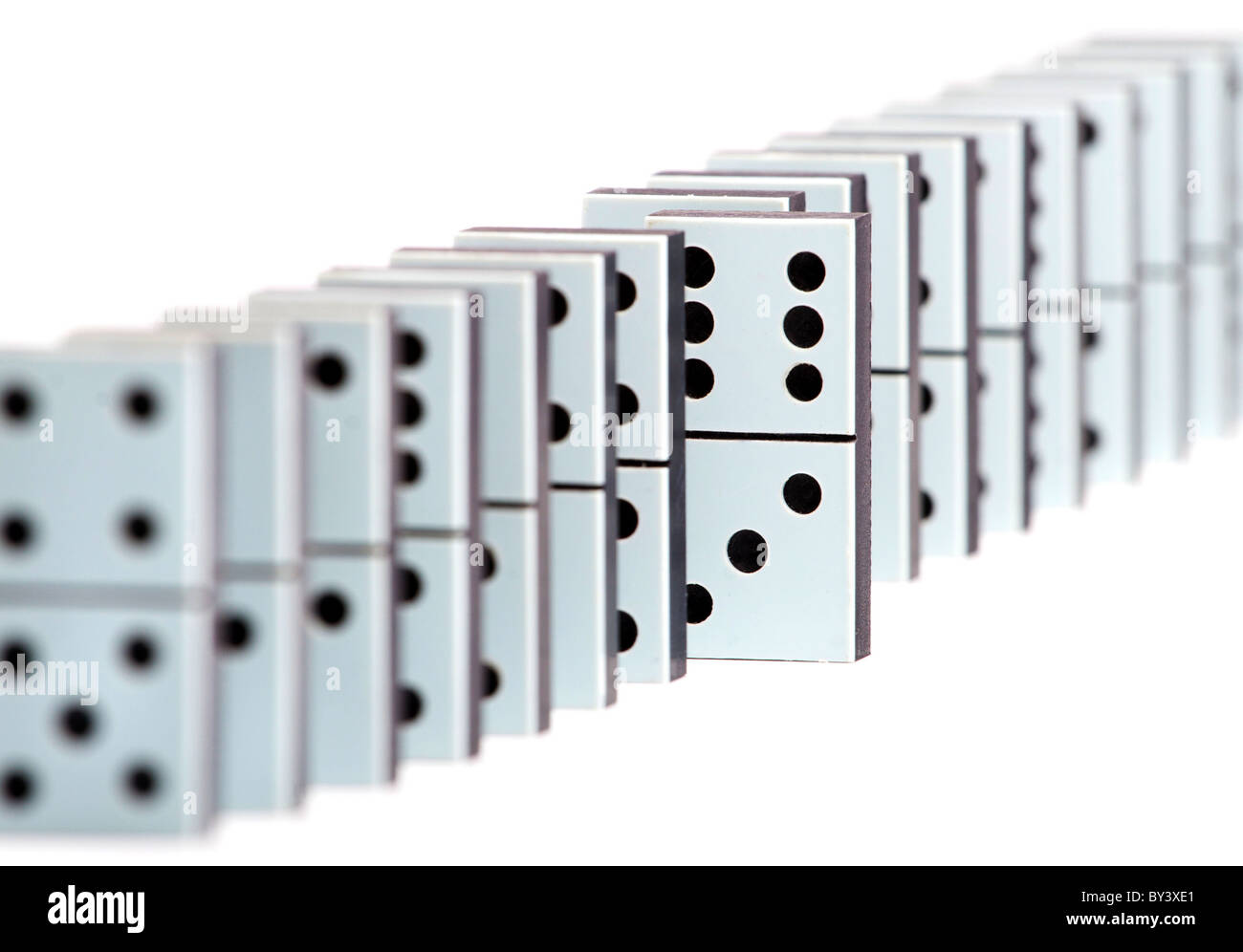 Domino pieces in a line on white background Stock Photo - Alamy