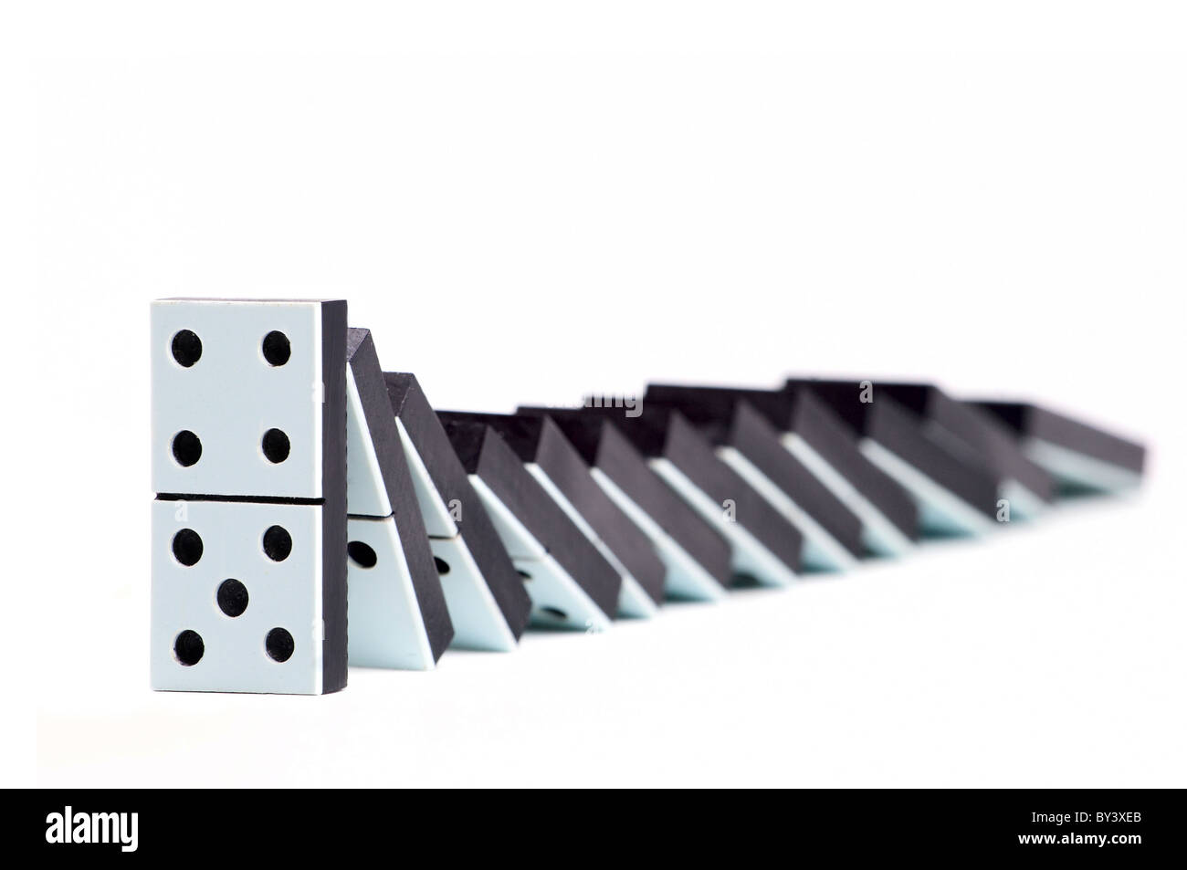 Domino pieces in a line on white background Stock Photo - Alamy