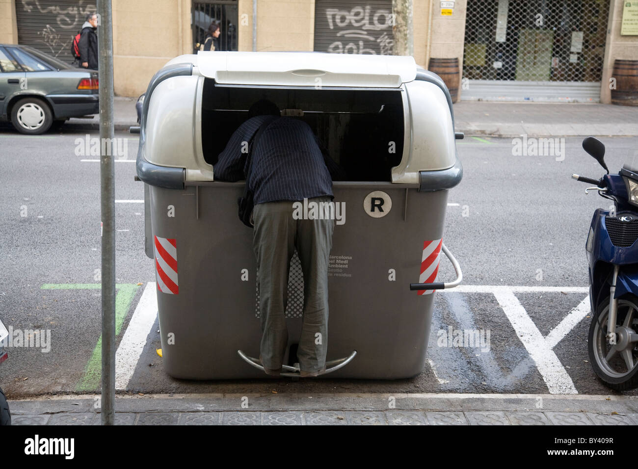 Man looking inside a rubbish container for whatever he can find Stock ...