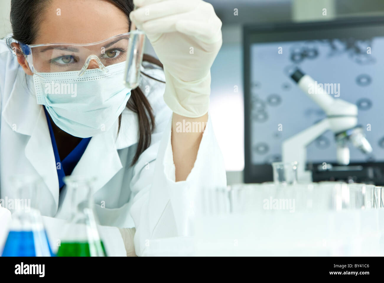 A female medical or scientific researcher or woman doctor looking at a ...