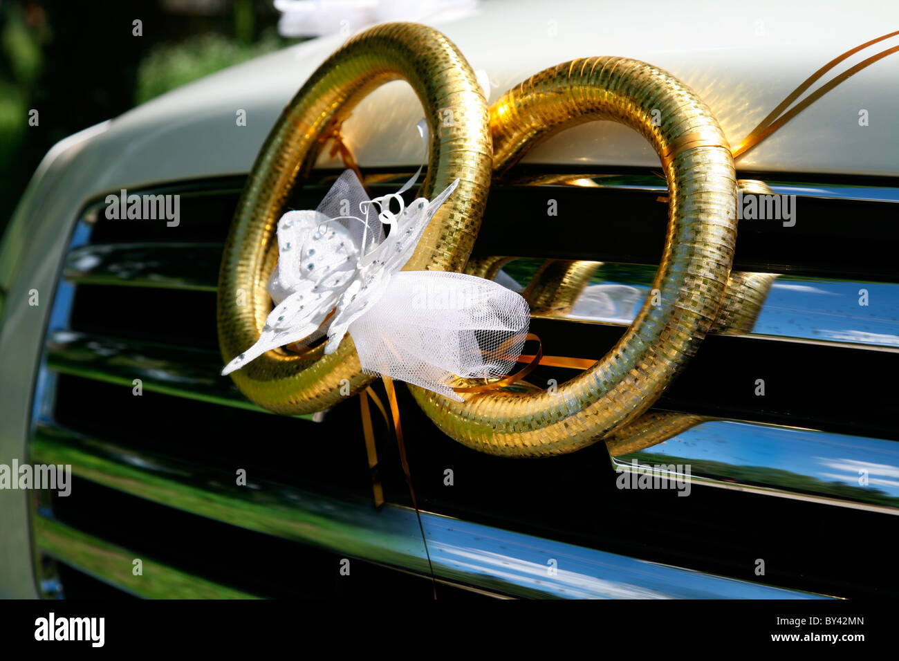 Image of gold two rings hanging on the car in front Stock Photo - Alamy